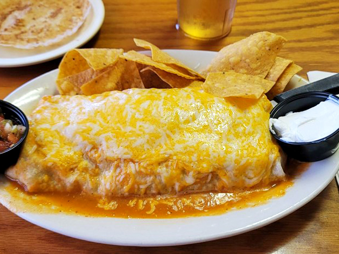 The breakfast burrito arrives generously stuffed and smothered, proving size matters when hunger calls.