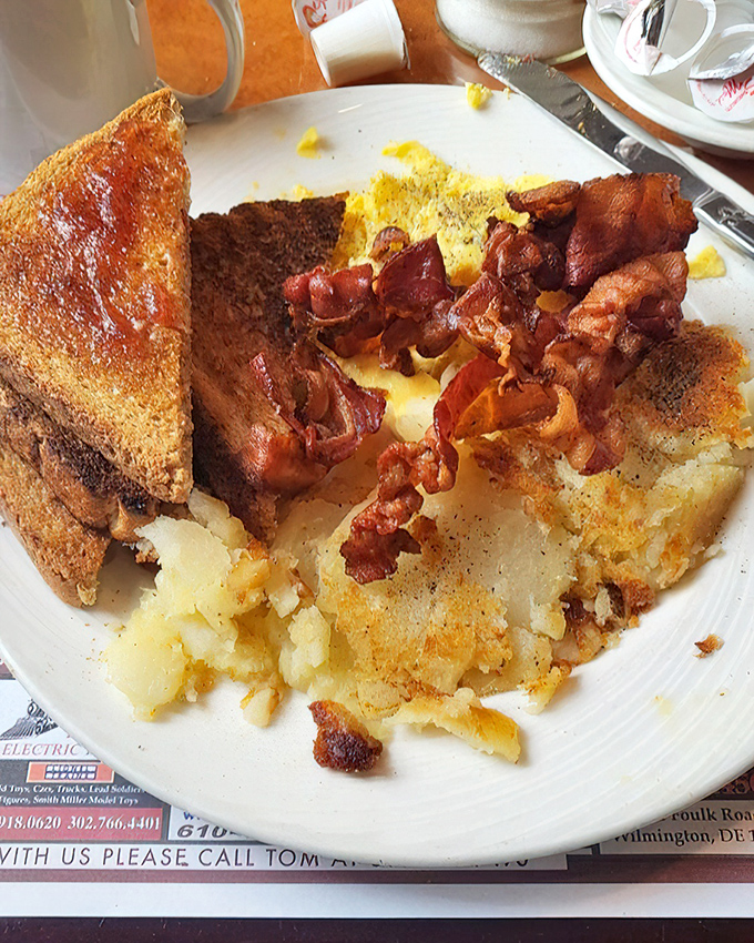 The holy trinity of breakfast: perfectly crisped bacon, golden home fries, and toast ready for whatever jam adventure you choose to embark upon.