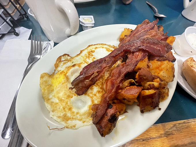 Breakfast platters that laugh in the face of moderation. The bacon is exactly how you want it – somewhere between crisp and chewy, like edible harmony.