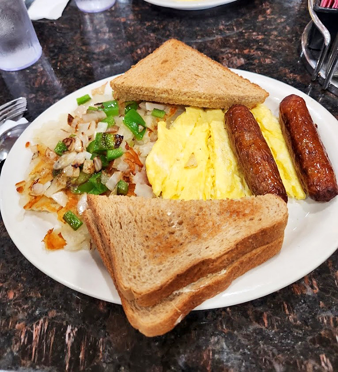 The classic American breakfast platter—where eggs, sausage, and toast conspire to create the kind of morning that Norman Rockwell wished he could have painted.