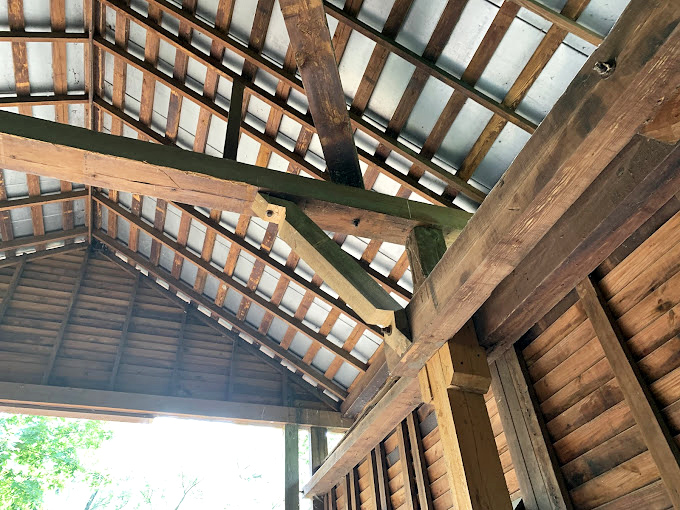 Overhead, a complex wooden puzzle of beams and supports demonstrates why 19th-century engineering still stands strong today.