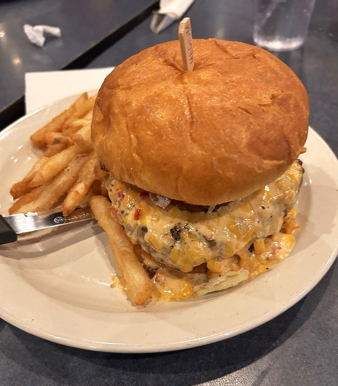 Not just a burger, but a towering monument to beef, cheese, and the American dream, complete with a bun that somehow contains the delicious chaos.