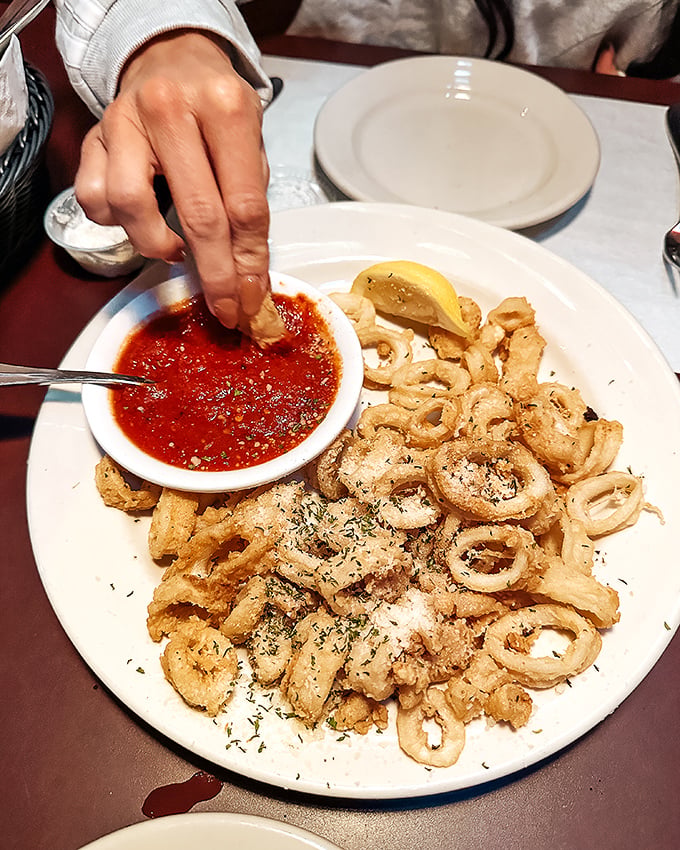 Golden-fried calamari that shatters with each bite, ready for a dip in that vibrant marinara. Crispy perfection that disappears from plates at record speed.