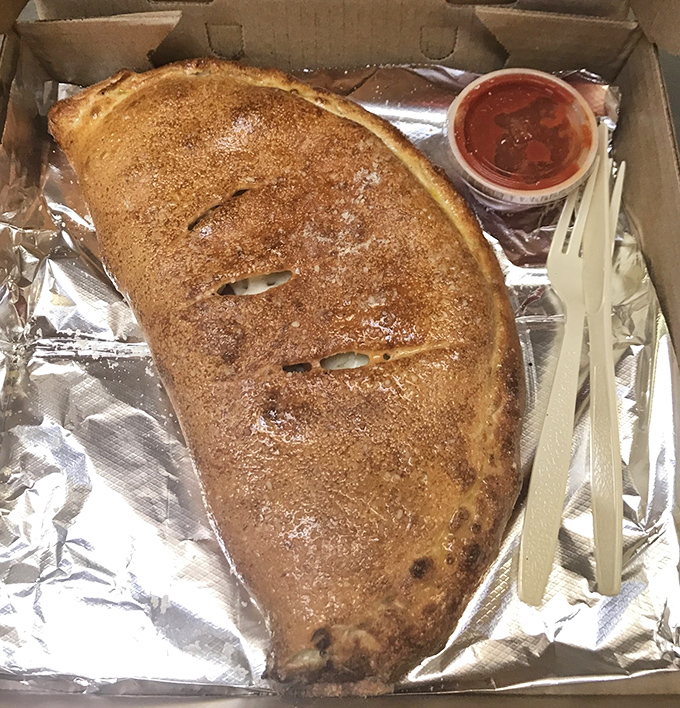Not all treasures come in chests. Some, like this golden-brown calzone, come in foil with dipping sauce and the promise of cheese-pull videos.
