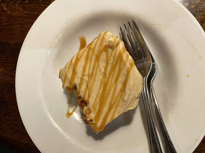 Dessert that doesn't whisper but shouts – a slice of carrot cake with cream cheese frosting drizzled with caramel that's worth saving room for.