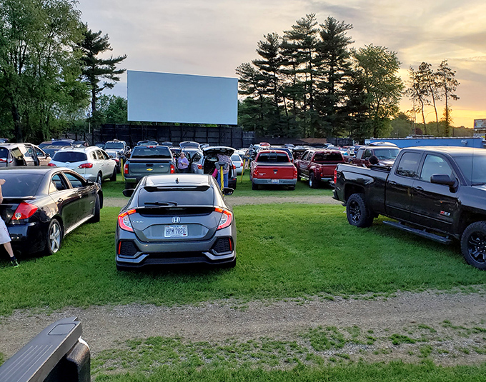 A patchwork of vehicles creates a community of movie lovers, each carving out their perfect viewing spot as sunset approaches.