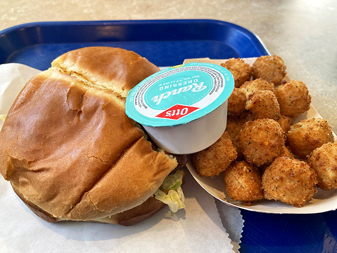 The ultimate comfort food combo &ndash; a hearty burger alongside golden-fried cheese cubes that somehow improve an already perfect meal.