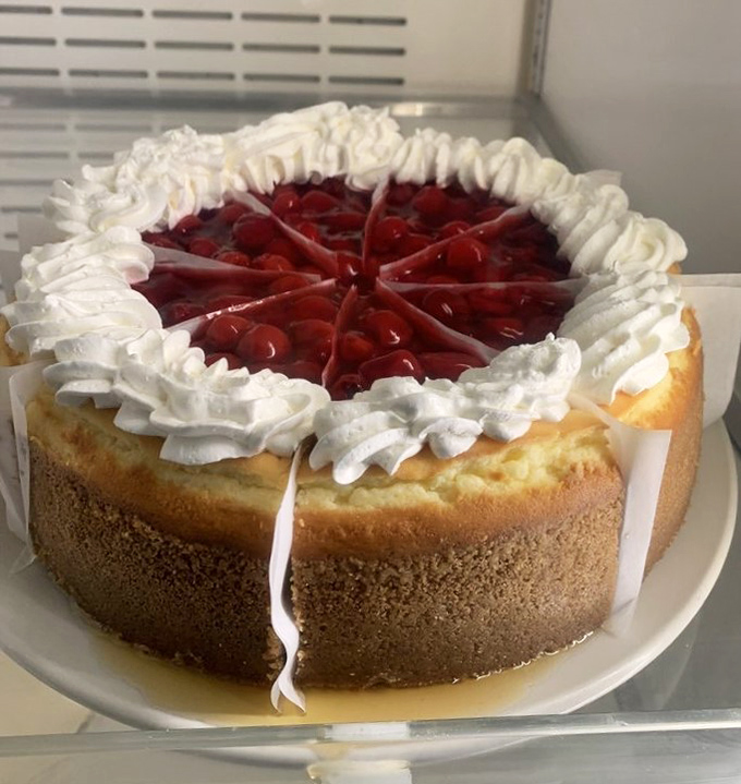 That cherry cheesecake sits pretty in the display case, practically winking at your sweet tooth.