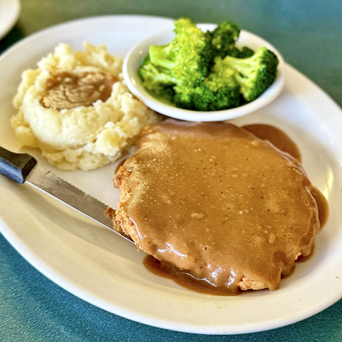 Country-fried steak swimming in gravy&mdash;proof that some of life's greatest pleasures don't need to be complicated, just perfectly executed.