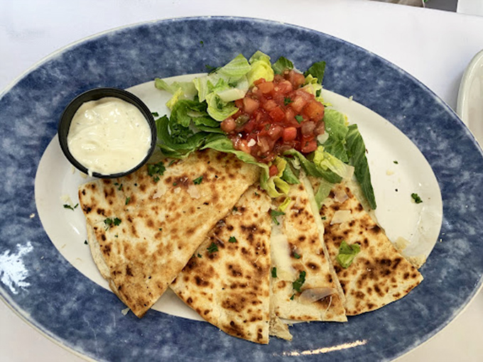 A quesadilla that's had a glow-up, served on blue stoneware that makes the fresh ingredients pop like a Florida sunset.