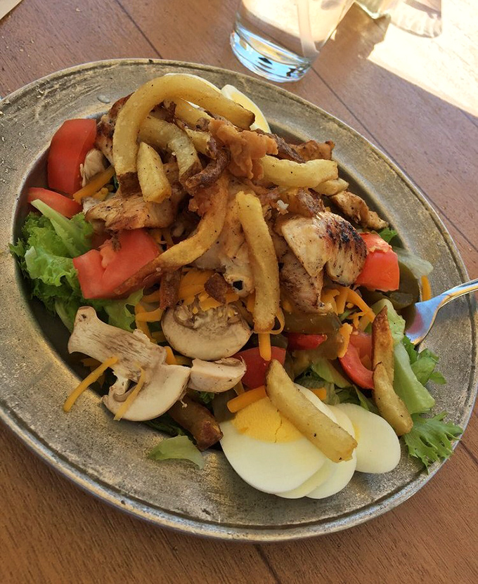 Garden-fresh ingredients meet culinary craftsmanship in this colorful salad topped with seasoned fries&mdash;proof that "eating light" doesn't mean sacrificing satisfaction.