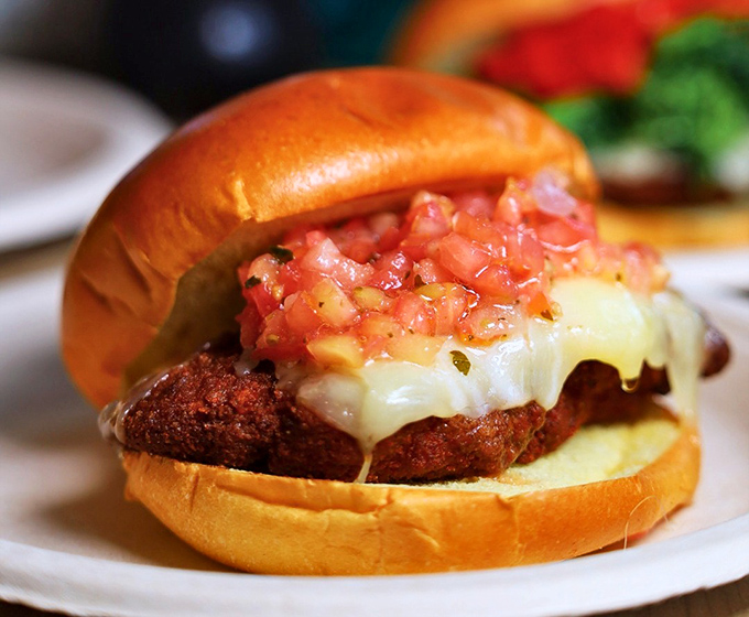 This chicken sandwich isn't just topped with tomatoes – it's wearing them like jewelry. Dressed to impress and ready for its close-up.