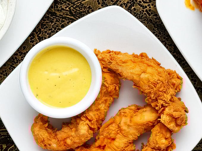 Golden-brown chicken tenders with that perfect crunch factor, served with honey mustard sauce. Some childhood favorites deserve to follow us into adulthood.