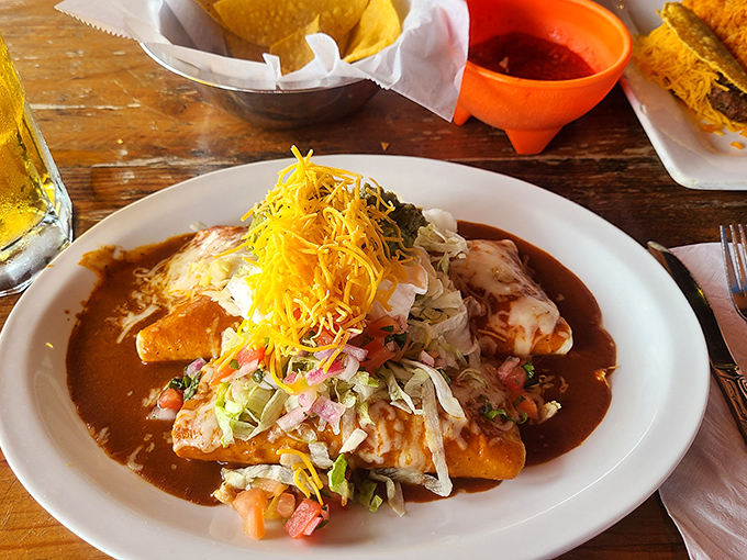 These enchiladas aren't just covered in sauce&mdash;they're having a full spa treatment in it. Rich, complex, and absolutely worth the napkin count. 