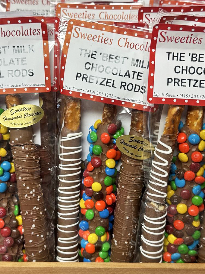 Chocolate pretzel rods dressed for success&mdash;some in tuxedo white chocolate, others flaunting colorful M&M confetti like they're heading to a party.