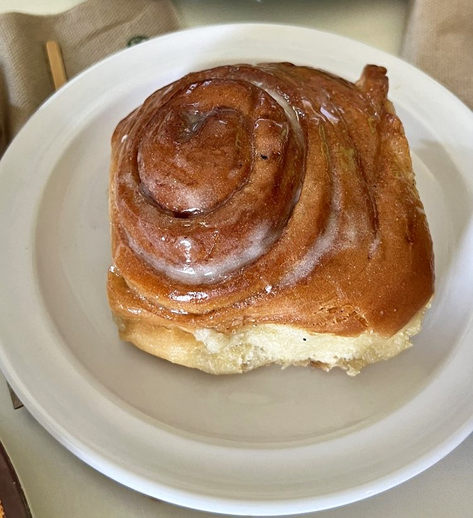 Spiral of happiness! This cinnamon bun's glistening glaze promises the kind of morning indulgence vacation memories are made of.