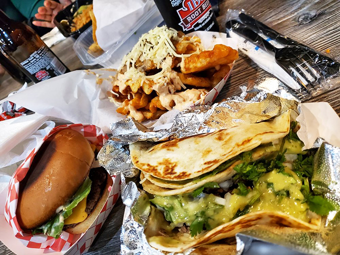 The holy trinity of comfort food: burger, tacos, and loaded fries, proving that sometimes more really is more.