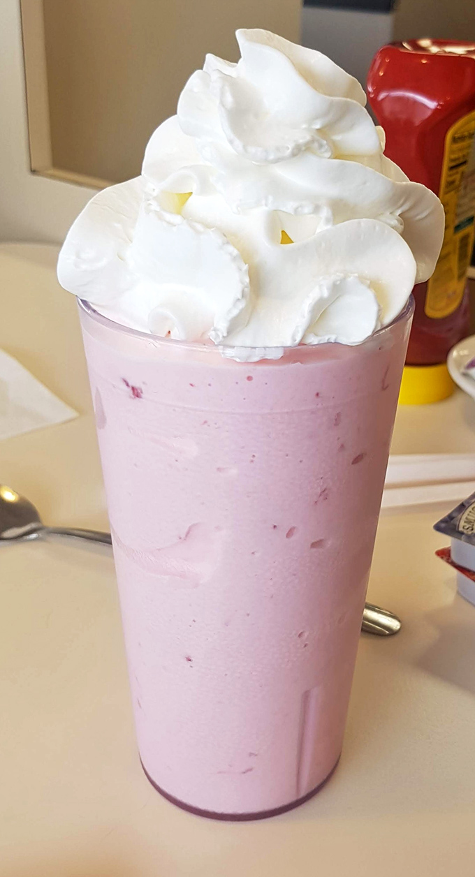 A strawberry milkshake towering with whipped cream&mdash;dessert masquerading as a beverage, and nobody's complaining about the deception.