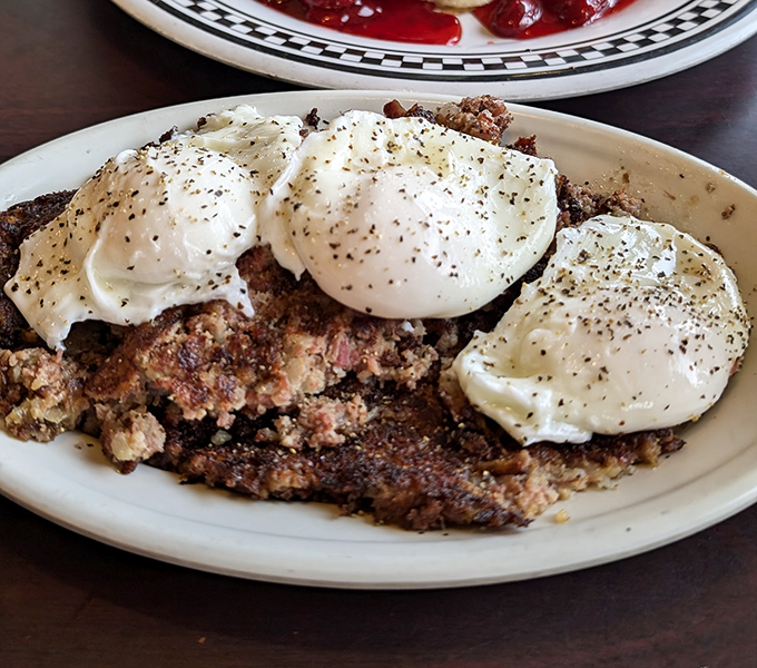 Corned beef hash crowned with poached eggs &ndash; a breakfast that says "you won't need lunch today" in the most delicious way possible.
