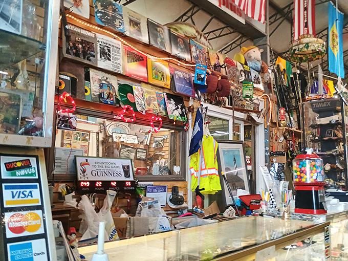 The checkout counter tells its own story—a collage of memorabilia, credit card signs, and the accumulated wisdom of years in the business.