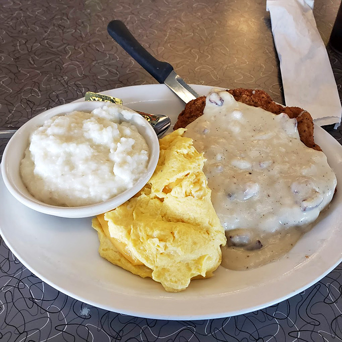 Country fried steak smothered in gravy that could make your grandmother jealous, with eggs and grits playing perfect supporting roles.