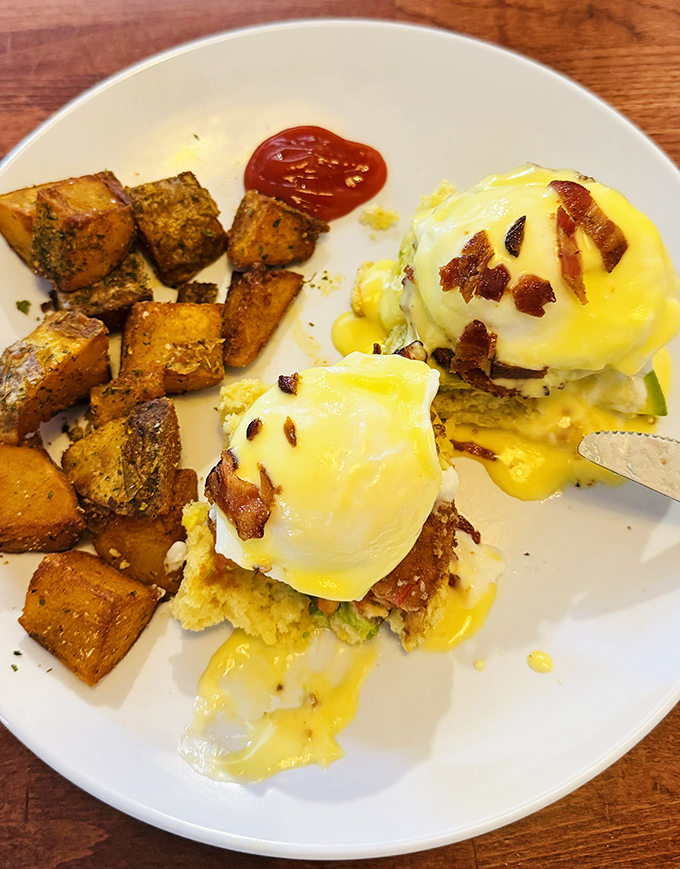 Benedict elevated: perfectly poached eggs perch atop crispy potato cakes, draped in hollandaise and crowned with bacon that would make any breakfast lover weak at the knees.