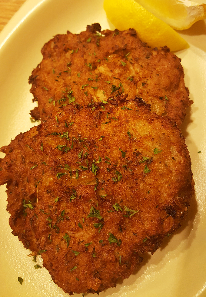 Crab cakes with a golden crust and flecks of herbs. No unnecessary fillers here—just the star of the show getting its moment.