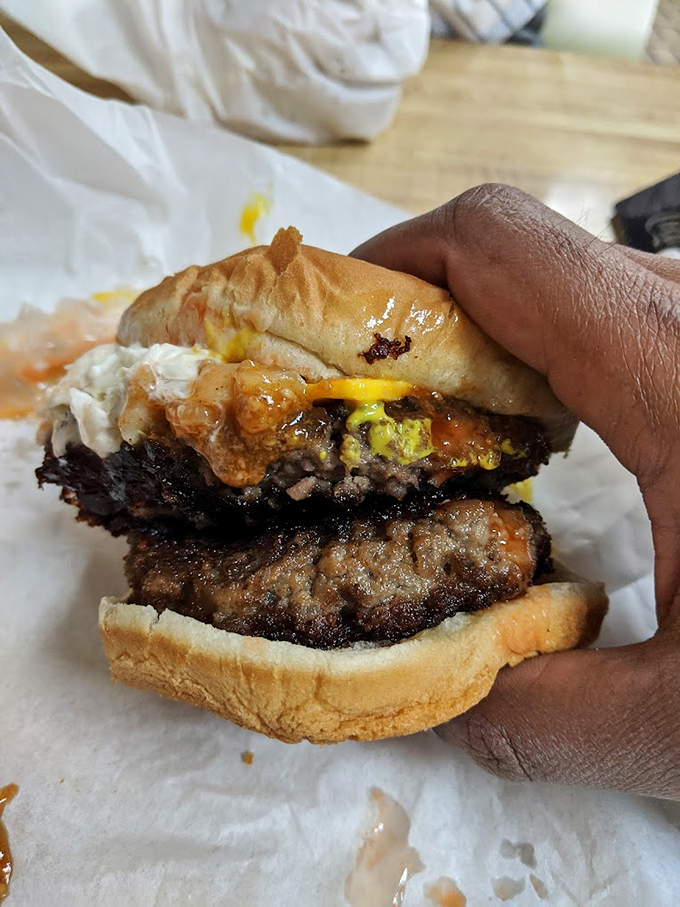 This double-decker burger isn't just a meal, it's a commitment. The kind of sandwich that demands both hands and zero distractions.