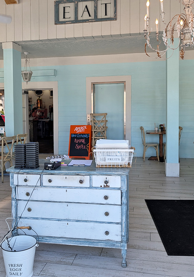 That "EAT" sign isn't just decoration&mdash;it's the most straightforward good advice you'll get all day. The distressed dresser adds charm that HGTV hosts would approve of.