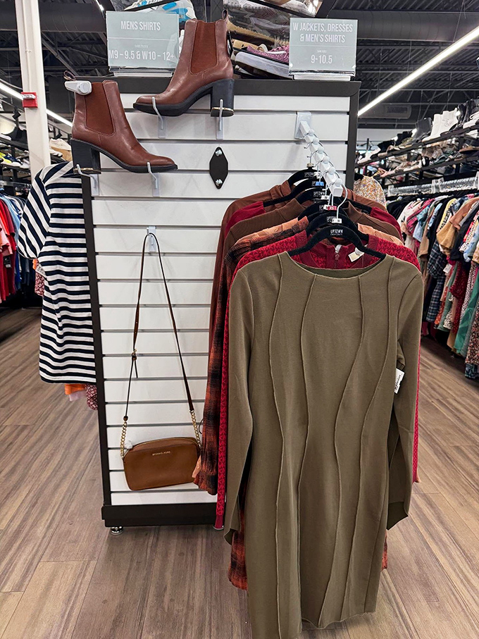 A perfectly styled display featuring rich autumn tones, classic Chelsea boots, and a Michael Kors crossbody&mdash;the secondhand trifecta.