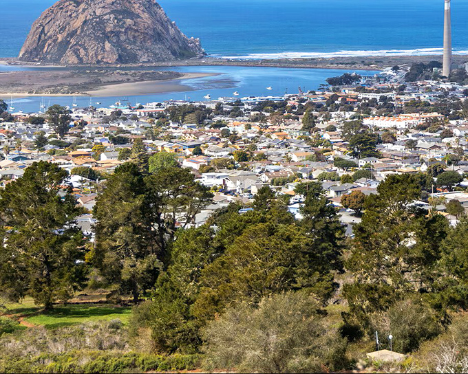 The town nestles between hills and ocean, a California postcard come to life, with Morro Rock standing guard over it all.