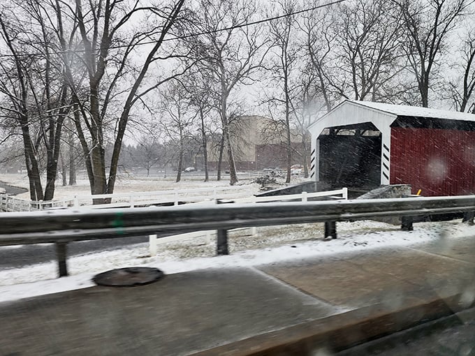 Winter transforms the bridge into a snow-dusted holiday card&mdash;the red and white structure standing out dramatically against the monochrome landscape.