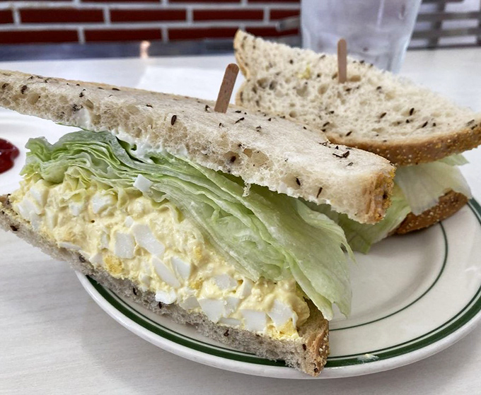 The famous egg salad sandwich—deceptively simple yet impossible to replicate at home. Creamy, fresh, and served on bread that knows its supporting role.