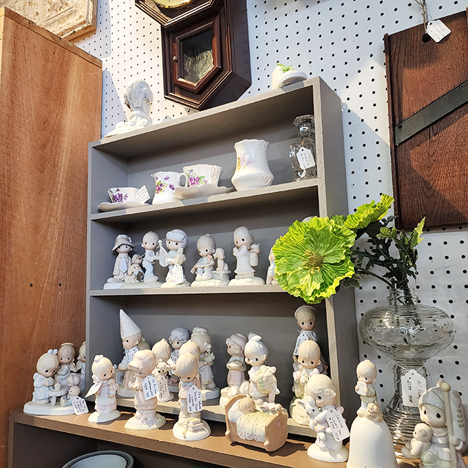 A congregation of Precious Moments figurines stands in silent testimony to decades of gift-giving occasions and curio cabinet prominence.