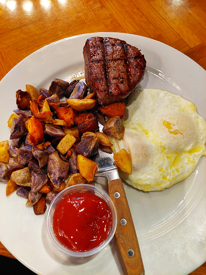 Breakfast of champions: a perfectly cooked filet mignon, colorful roasted vegetables, and an egg that's having its moment in the spotlight.