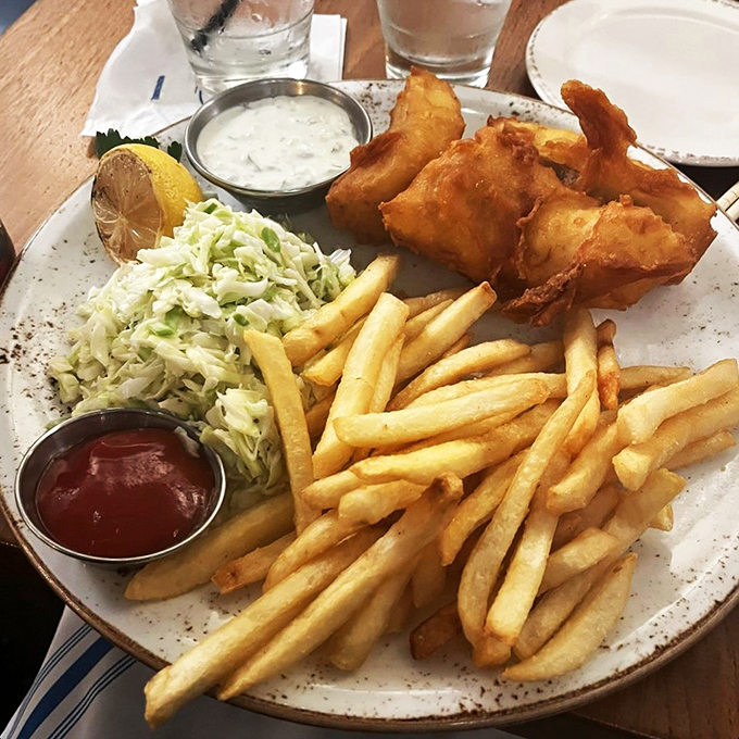 Fish and chips that would make a British pub weep with inadequacy&mdash;golden, crispy batter protecting flaky white fish like delicious armor.