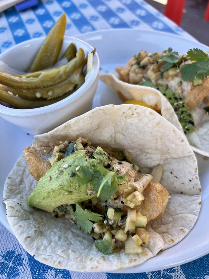 Fish tacos that understand the assignment: crispy fish, creamy avocado, and just enough cilantro to make you feel like you're making healthy choices despite the delicious fried exterior.