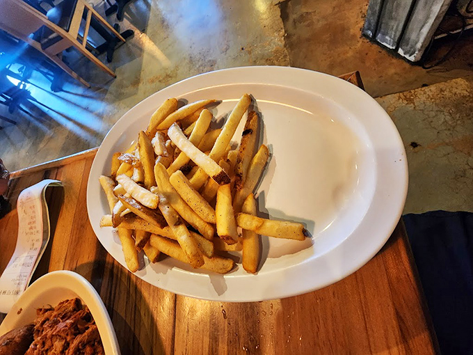 Golden fries scattered like edible confetti &ndash; the perfect vehicle for soaking up every drop of that precious barbecue sauce.