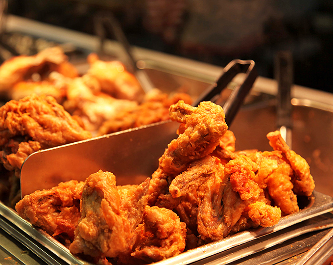 Fried chicken so perfectly golden, it belongs in Fort Knox. The kind of crispy exterior that makes a satisfying sound when your fork breaks through.