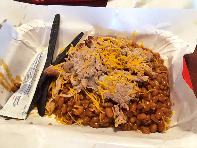 Frito pie topped with pulled pork and cheese&mdash;proof that sometimes the best culinary ideas sound like they came from a midnight refrigerator raid.
