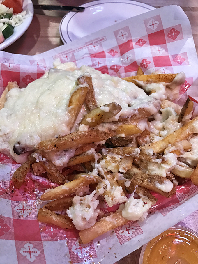 These aren't just cheese fries—they're a mountain of crispy potatoes blanketed in melty cheese that makes you wonder why you'd eat fries any other way.