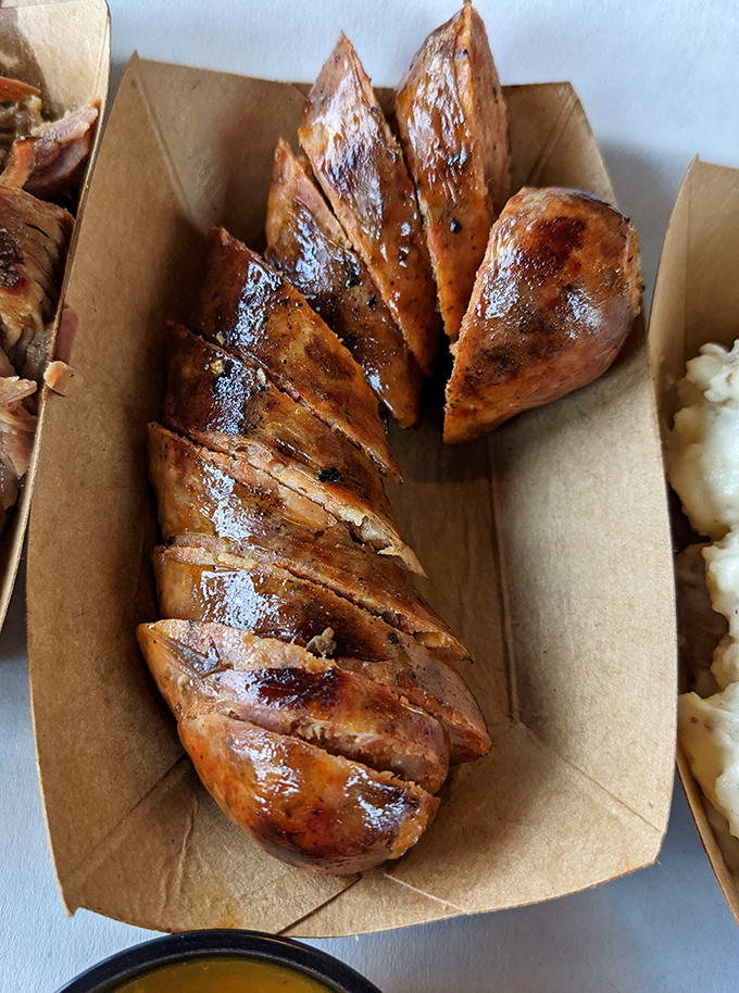 Gator sausage sliced and glistening with smoky goodness. When in Florida, eat as the Floridians do&mdash;with gusto and a side of adventure.