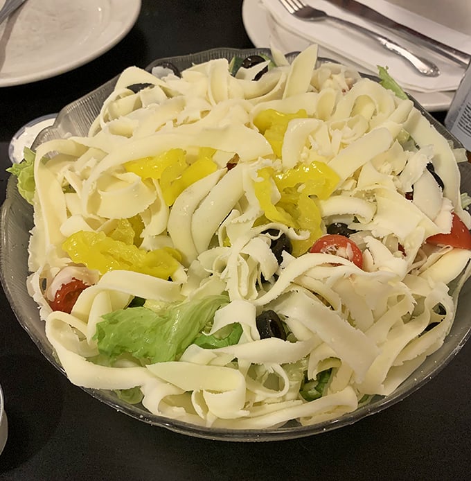 The house salad arrives like a snow-capped mountain of provolone. In Pittsburgh, even the vegetables come with a generous cheese blanket.