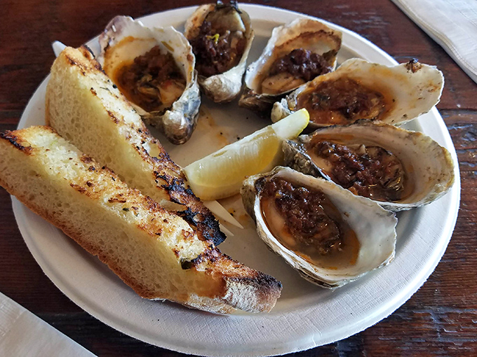 These grilled oysters aren't just seafood – they're little oceanic hot tubs of butter and herbs that make you want to dive right in.