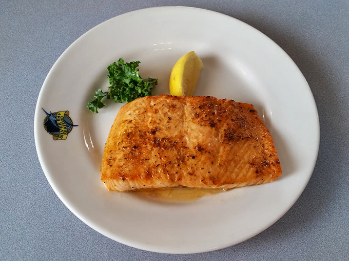 This grilled salmon doesn't need fancy garnishes to impress &ndash; just a lemon wedge, a sprinkle of herbs, and perfect flame-kissed execution.