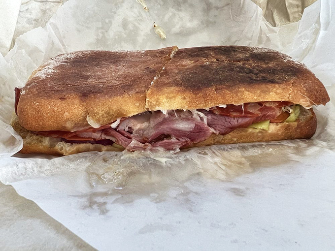 This isn't just a sandwich&mdash;it's an engineering marvel of crusty bread, savory meats, and fresh vegetables that demands both hands and your full attention.