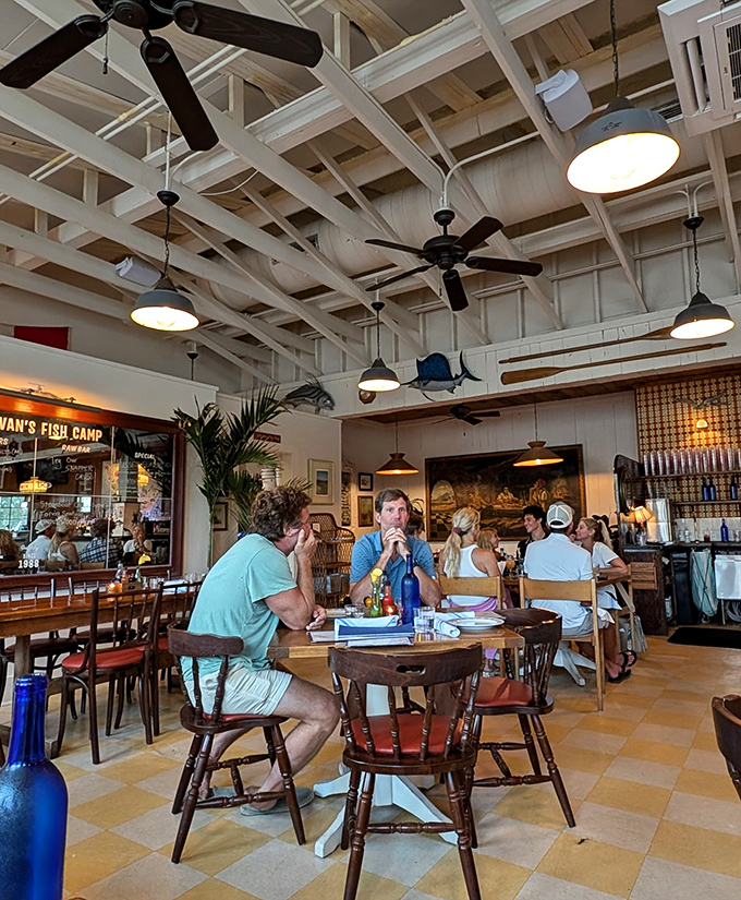Under white-beamed ceilings and spinning fans, diners gather at wooden tables to share stories and seafood, creating memories as delicious as the meals.