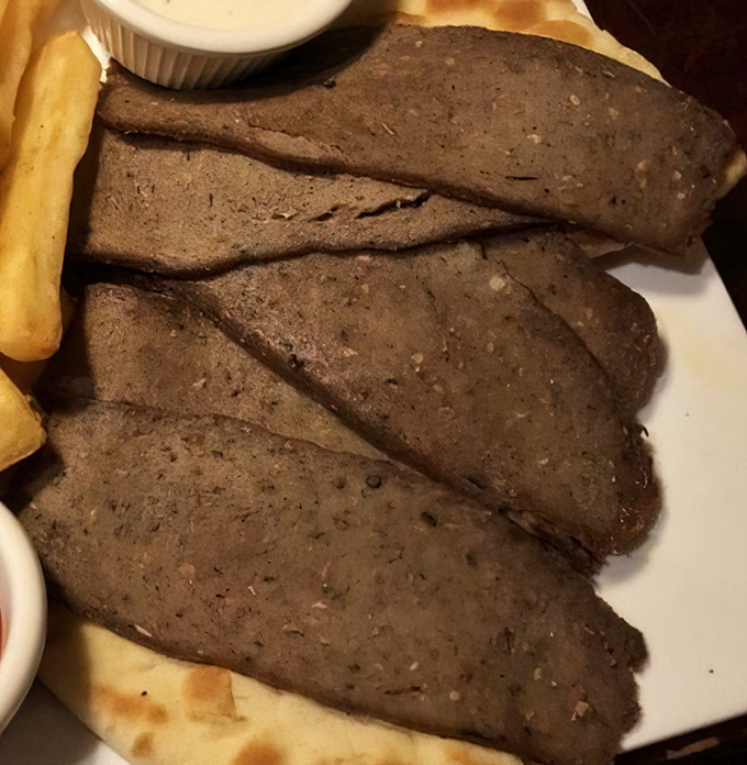 Sliced gyro meat that would make Zeus himself descend from Olympus. Paired with those golden fries, it's a Mediterranean vacation on a plate.
