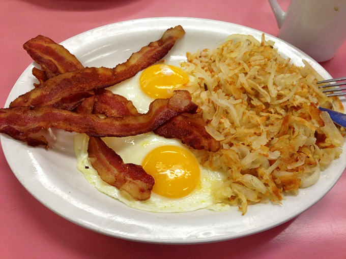 Two sunny eggs with bacon and hash browns&mdash;the breakfast equivalent of a perfect day where everything goes right from the moment you wake up.