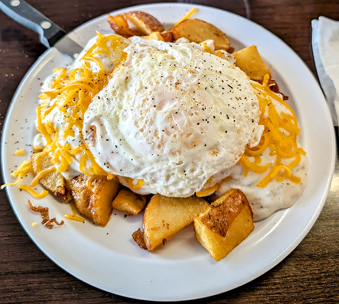 Breakfast architecture at its finest&mdash;crispy potatoes, melted cheese, and an egg that looks like it's posing for its glamour shot.